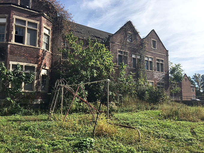 A haunting reminder of neglect, this wing shows how quickly abandonment accelerates decay, with vegetation already claiming territory through the roof.