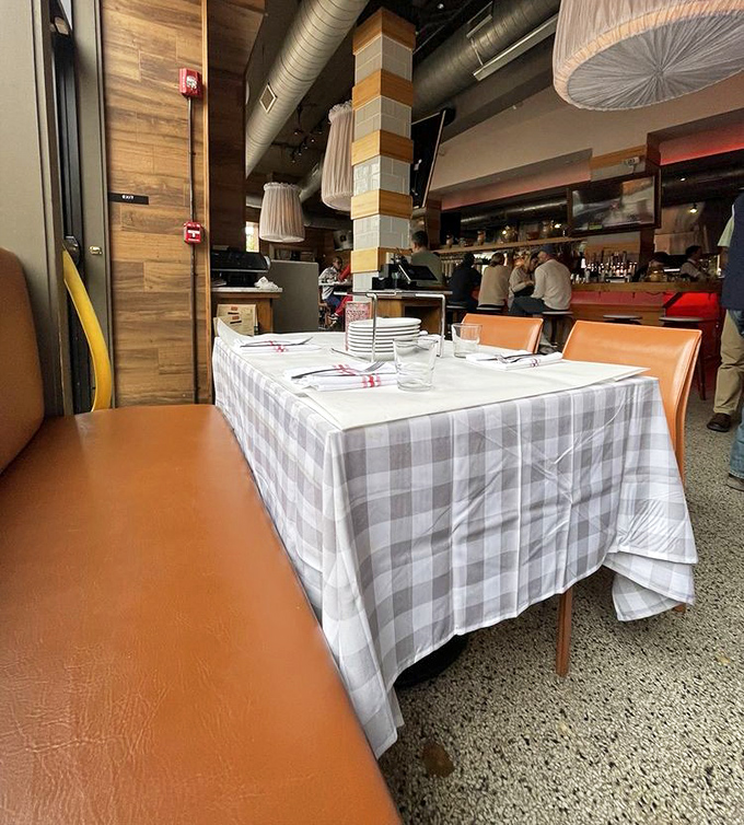 Checkered tablecloths and cognac-colored booths create that perfect "I'm somewhere special but completely comfortable" vibe that makes you want to linger.