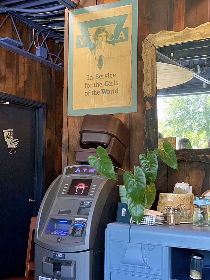 Vintage signs and blue accents create a space that feels both nostalgic and current &ndash; like your coolest friend's kitchen.