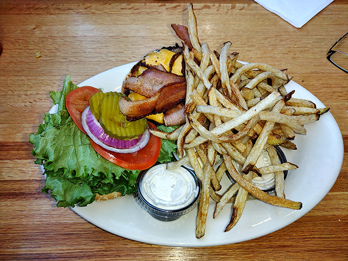 A burger that doesn't need fancy aioli or artisanal buns to impress&mdash;just honest ingredients stacked high enough to require jaw exercises beforehand.