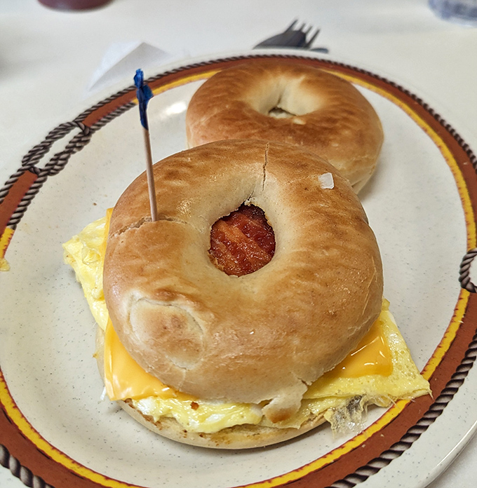 A bagel sandwich that understands the importance of proper cheese-to-egg ratio, with bacon playing the perfect supporting role.
