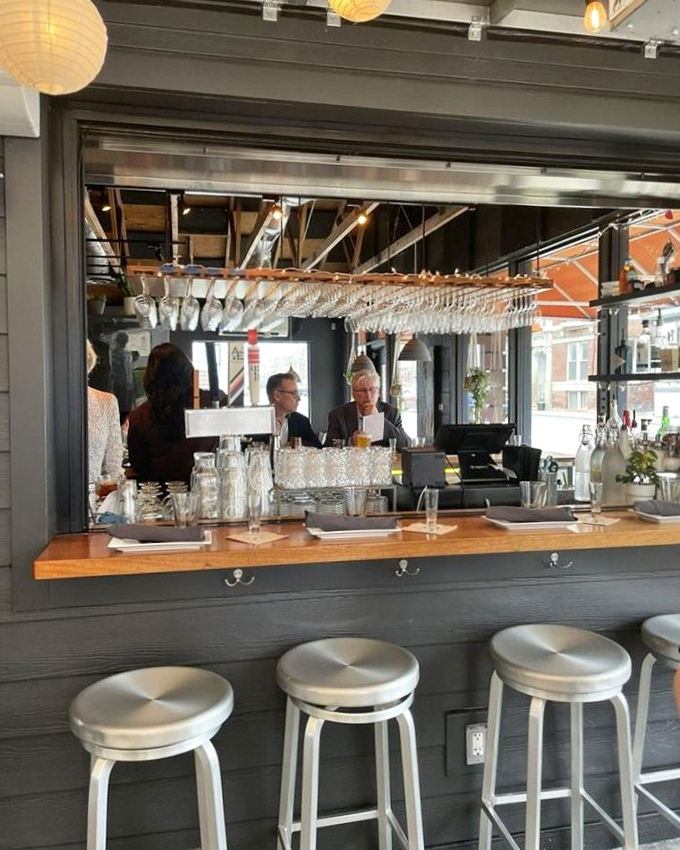 The bar isn't just for drinks &ndash; it's theater seating for the cocktail show, where glassware gleams and conversations flow as freely as the spirits.