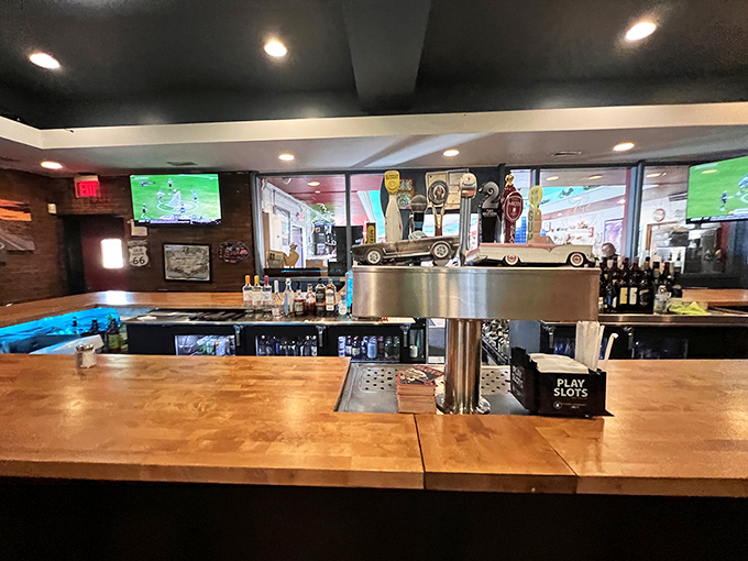 The bar area combines sports viewing with serious eating, where cold drinks meet hot wings perfectly.