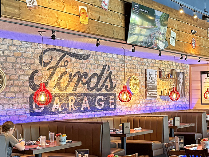 Booth seating that feels like sitting in a classic car's interior. The warm lighting and brick walls create a cozy dining experience.