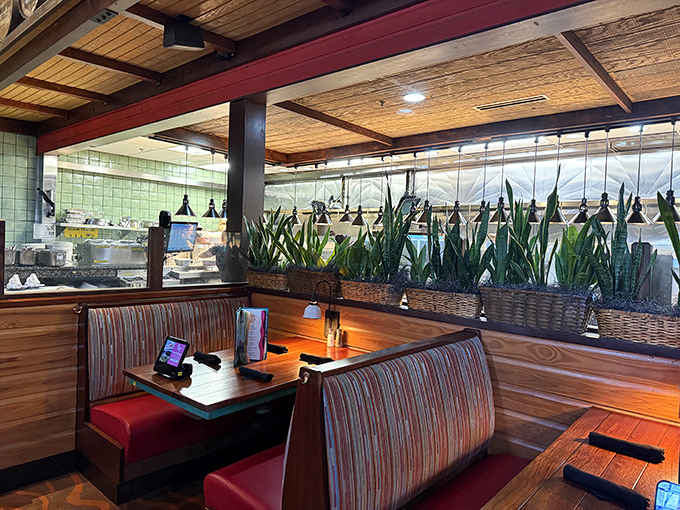 Cozy booths framed by lush greenery create intimate dining spaces that feel worlds away from the Pennsylvania parking lot outside.