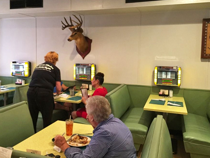 Mounted deer heads and tabletop jukeboxes create that quintessential small-town restaurant vibe where comfort extends beyond just what's on your plate.