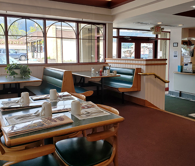 Classic booth seating arranged for optimal coffee refill efficiency &ndash; these tables have heard more morning confessions than most therapists.