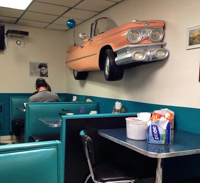 That vintage car bursting through the wall isn't just decoration&mdash;it's a metaphor for how this diner crashes through the barrier between past and present.
