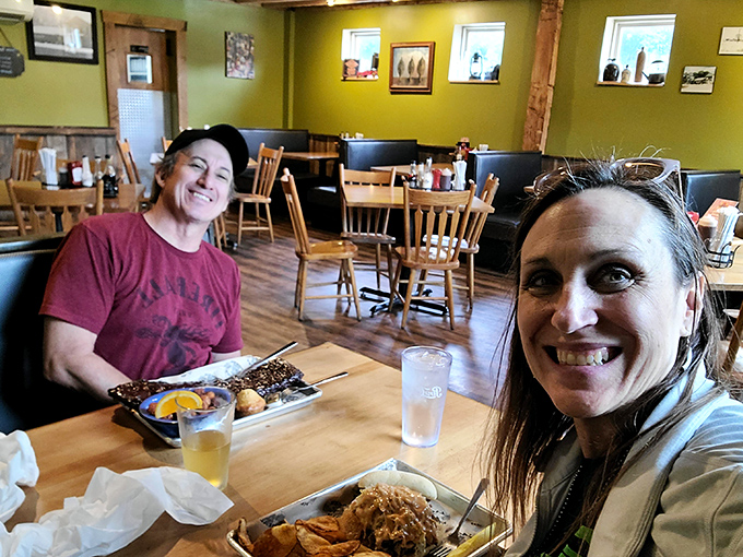 The dining area where friendships deepen over shared plates and sauce-stained napkins. Green walls somehow make the barbecue taste even better.