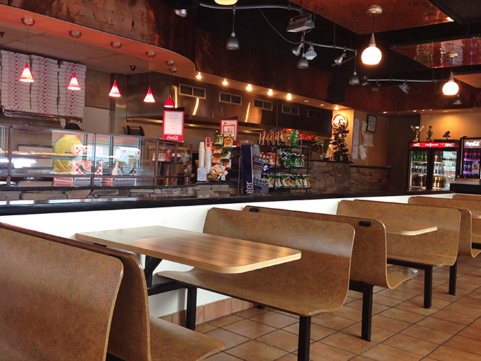 Comfortable booth seating where countless breadstick conversations have cemented friendships and satisfied serious appetites over time.