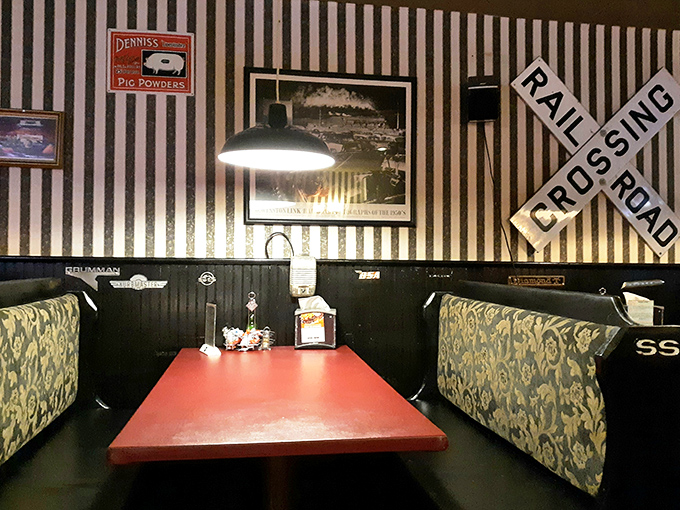 Railroad crossing signs and striped wallpaper create the perfect booth sanctuary. Some restaurants understand that atmosphere is the silent ingredient in every dish.