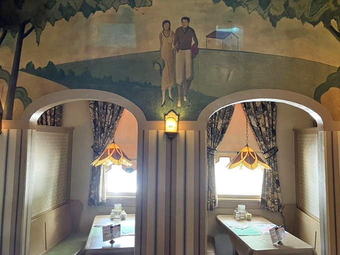 Cozy booths beneath a pastoral mural that whispers, "Slow down, friend. Your emails can wait." Stained glass lamps cast the perfect glow for comfort food consumption.