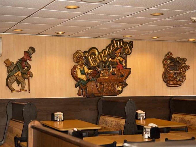 Wooden wall carvings of Pinocchio characters watch over diners like guardians of good taste and hearty appetites.