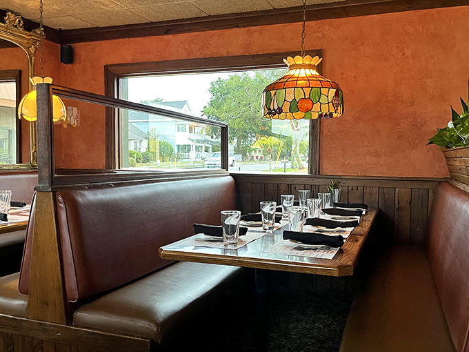 Cozy leather booths under stained glass pendants—where intimate conversations happen and diet plans go to die. Worth every calorie.