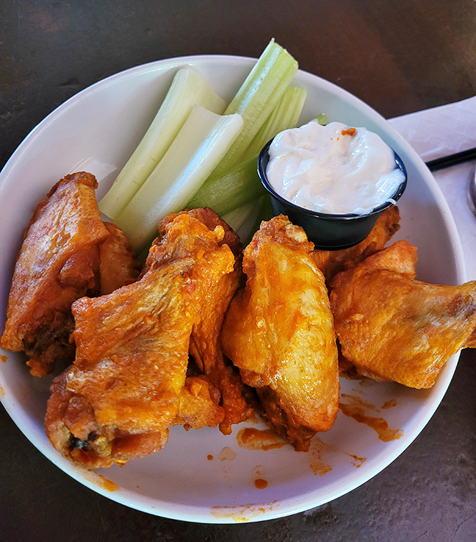 Buffalo wings: the ultimate test of any tavern's mettle, passed with flying colors and enough sauce to warrant that stack of napkins at your elbow.