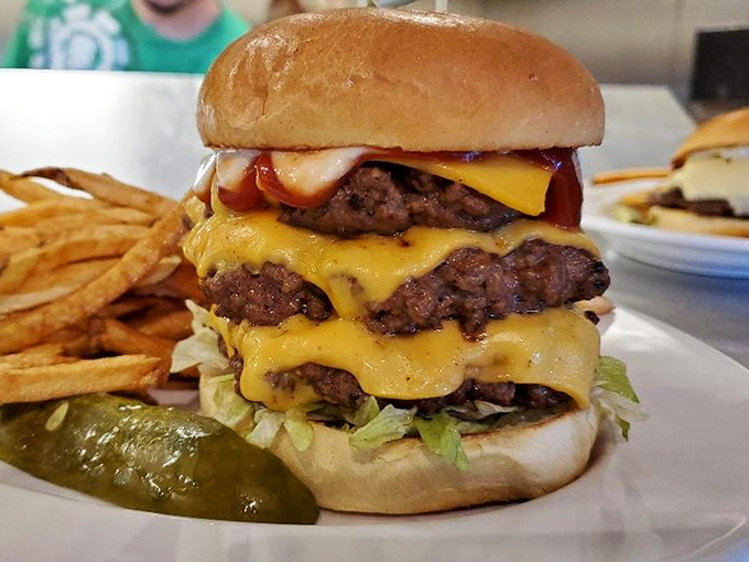 A burger that requires both hands, a stack of napkins, and possibly a nap afterward. Worth every delicious, cheese-draped, multi-patty bite.