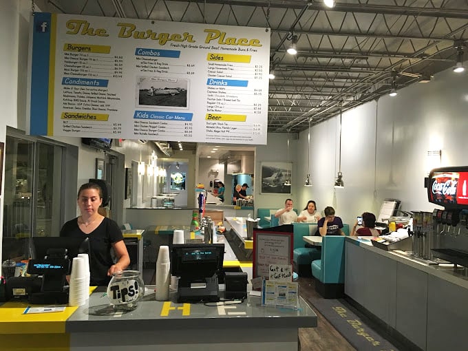 The ordering counter gleams with promise, a portal between hunger and satisfaction where friendly faces guide you to burger bliss.