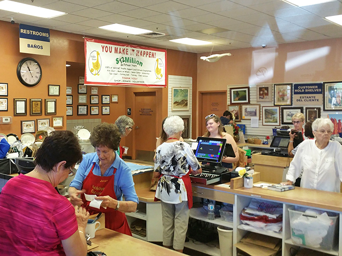 The checkout area buzzes with community energy. That sign announcing "$6 Million" in donations reminds you this shopping spree actually helps your neighbors.