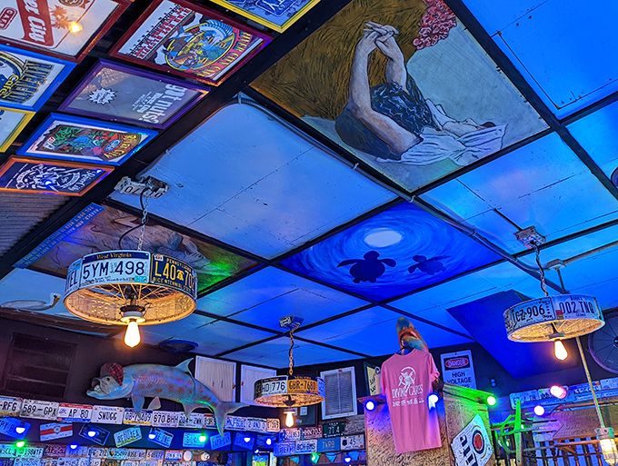 Even the ceiling tells a story with license plates transformed into light fixtures. Roadside Americana elevated to functional art.