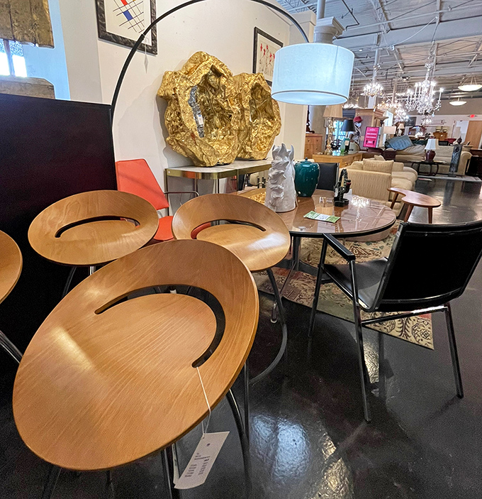 Sculptural wooden chairs that prove comfort and art aren't mutually exclusive. That arc lamp hovers like a question mark, asking "Why haven't you redesigned your living room yet?"