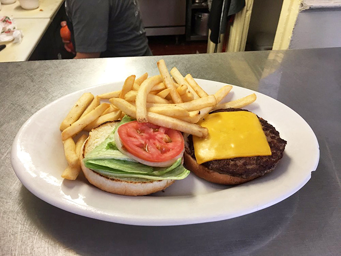 Cheeseburger simplicity at its finest &ndash; hand-formed patty, melty American cheese, fresh veggies, and a side of fries that didn't come from a freezer.