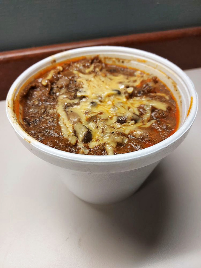 Chili that looks like it's been simmering since the Carter administration. Topped with melted cheese that stretches like the truth at a fishing derby.