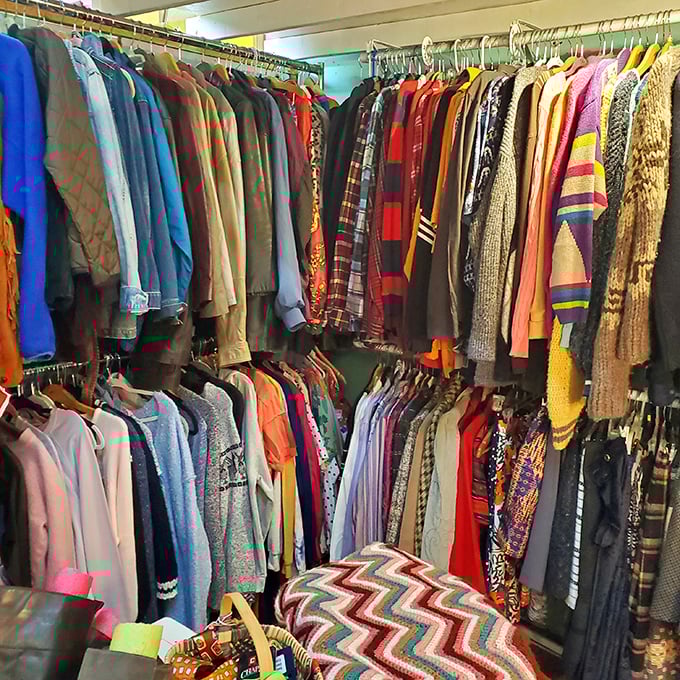 The clothing section resembles a textile rainbow—each hanger holding someone's former fashion statement waiting for its comeback tour.