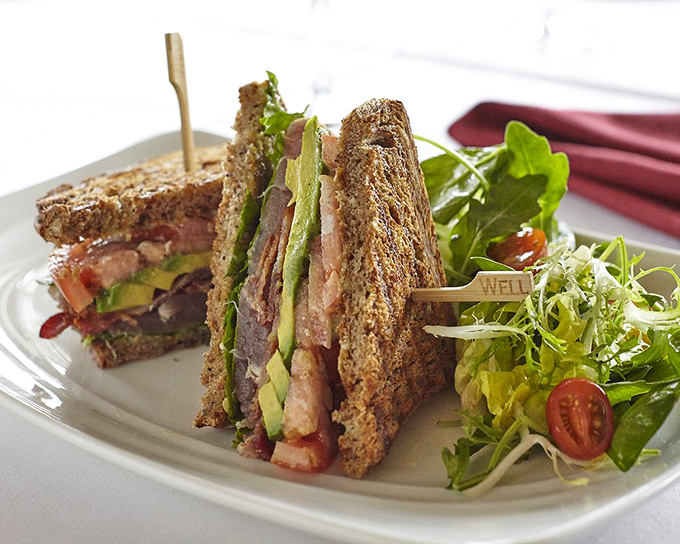 This isn't just a sandwich; it's architecture with avocado. The perfect cross-section reveals layers of flavor that make lunch feel like an event.