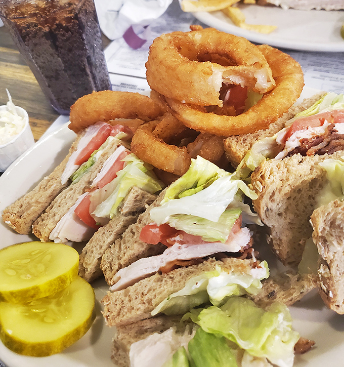 The club sandwich&mdash;America's greatest contribution to lunch&mdash;stacked high with the promise of satisfaction and those essential crispy onion rings.