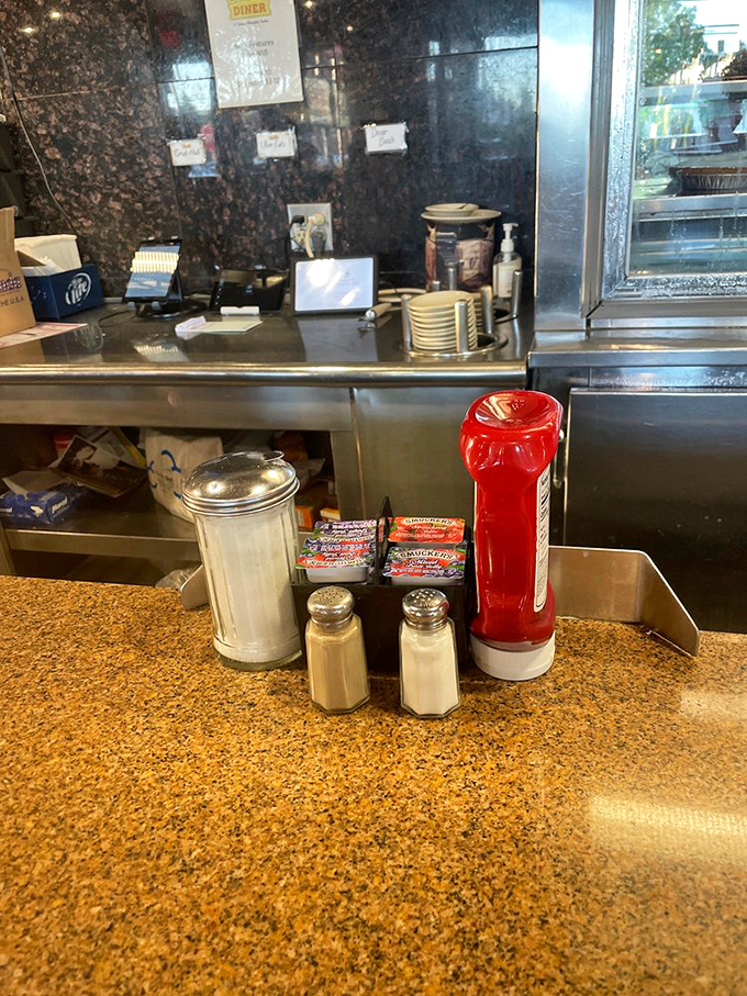 Those classic diner condiments&mdash;salt, pepper, and ketchup&mdash;standing at attention, ready to enhance whatever comfort food masterpiece arrives at your table.