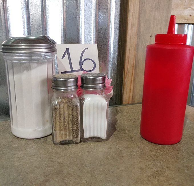 Table 16's salt, pepper, and ketchup - the holy trinity of condiments that complement rather than complicate good cooking.