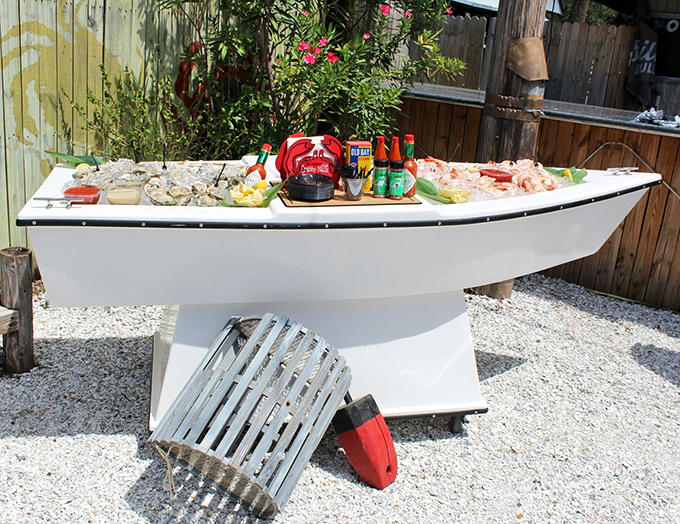 Not just a seafood display&mdash;it's a boat-shaped altar to oceanic delights, where condiments stand ready for their supporting roles.
