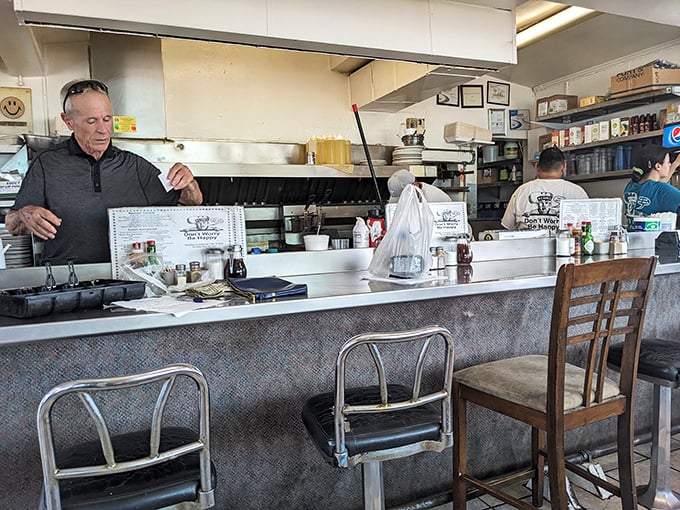 At the counter, where the magic happens. Watch as short-order wizardry unfolds and breakfast dreams become delicious reality.