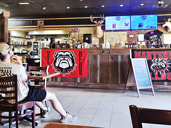 Behind that counter, barbecue magic happens daily. The mounted deer head isn't judging your order&mdash;he's jealous he can't join the feast.
