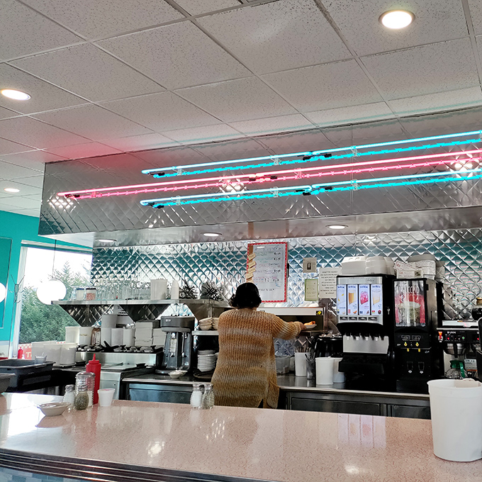 Behind the counter magic where coffee flows freely and short-order wizardry happens. Those neon lights aren't just decoration—they're mood enhancers.