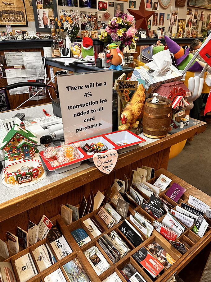 The counter area doubles as a small-town museum, where business cards and candy coexist in a delightful jumble of local commerce.
