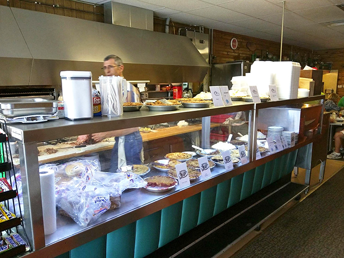 The pie display case—a glass-fronted temple of temptation where willpower goes to die a delicious death.