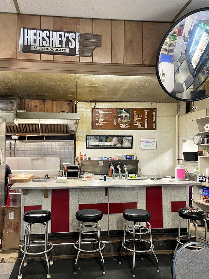 The red and white counter with classic barstools invites you to pull up a seat and join the community of burger believers.