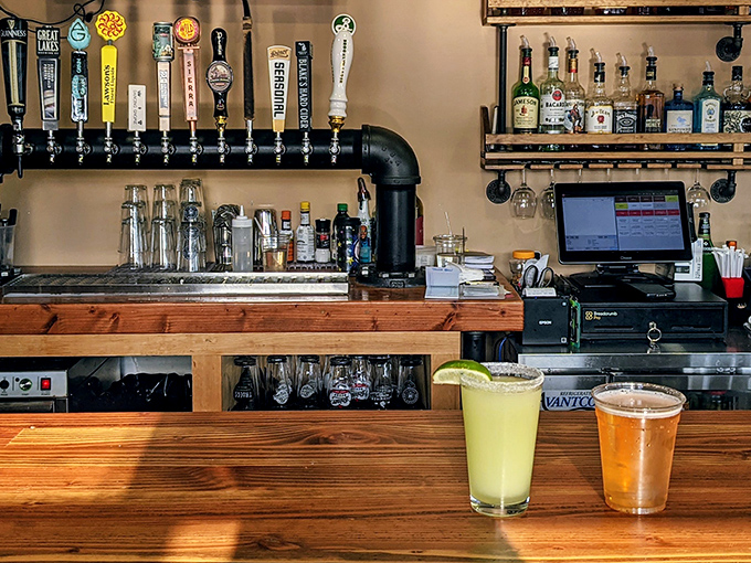 Behind this bar, draft beers flow like liquid optimism, each tap promising a perfect pairing for whatever smoked delight you've chosen.