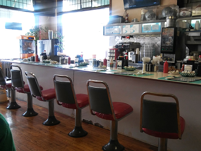 Counter culture at its finest—where solo diners find community and the best view of short-order choreography in town.