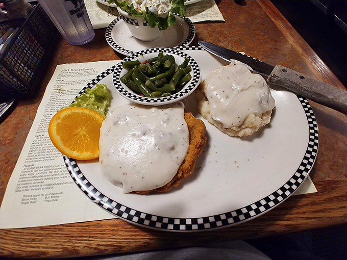 Country fried steak smothered in gravy—where "diet" is just a four-letter word and green beans provide the illusion of nutritional balance.