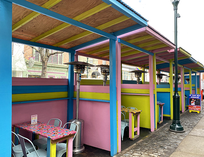 Outdoor dining booths painted in colors that would make Frida Kahlo nod in approval. Weather permitting, this is where memories are made.