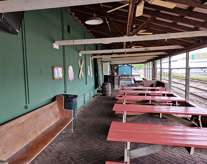 The covered patio offers al fresco dining with a side of nostalgia. Those picnic tables have probably witnessed countless celebrations and first dates. 