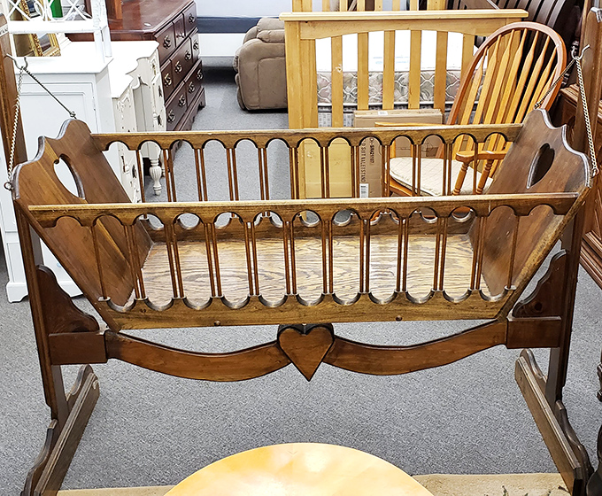 Handcrafted history in wooden form. This baby cradle has likely witnessed first smiles and midnight feedings across decades of family life.