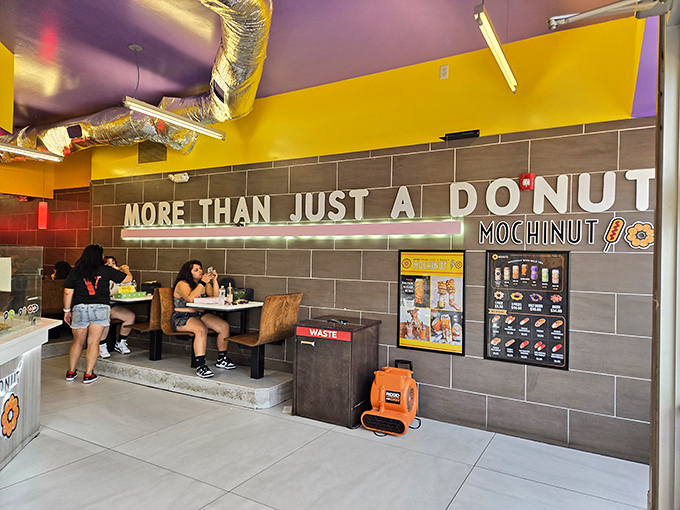 The modern interior combines purple ceilings with industrial elements, creating the perfect backdrop for your donut photoshoot.