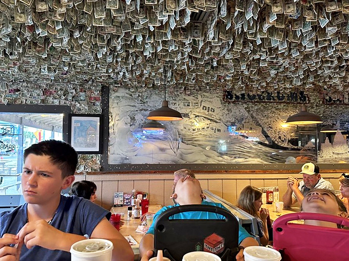 When your restaurant decor doubles as an emergency fund. These walls have heard more vacation stories than a travel agent on commission.