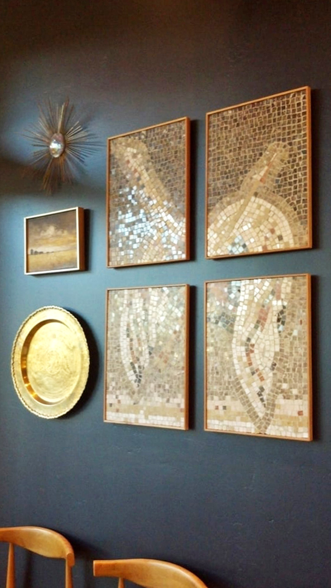 The deep blue walls adorned with mosaic artwork create a sophisticated backdrop that elevates your morning coffee from routine to ritual.