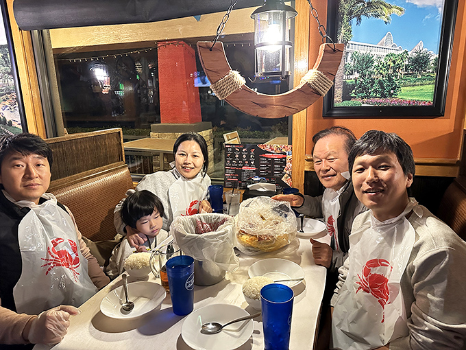 Plastic bibs aren't just practical&mdash;they're ceremonial robes that initiate you into the messy, joyful cult of seafood lovers.