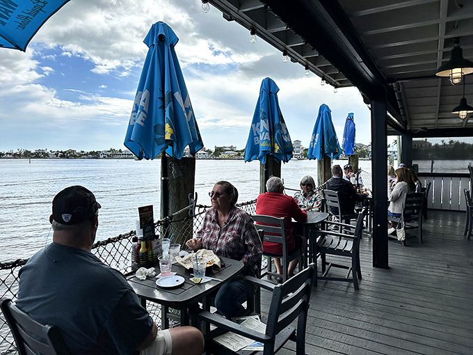 Happy diners enjoying fresh catches while boats drift by &ndash; this is Florida living at its finest.