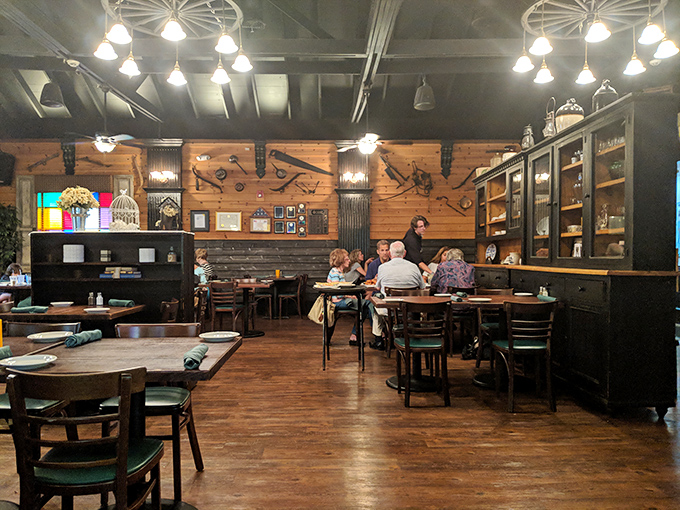 The dining room welcomes patrons with warm wood, vintage tools as d&eacute;cor, and the promise of meals worth lingering over.